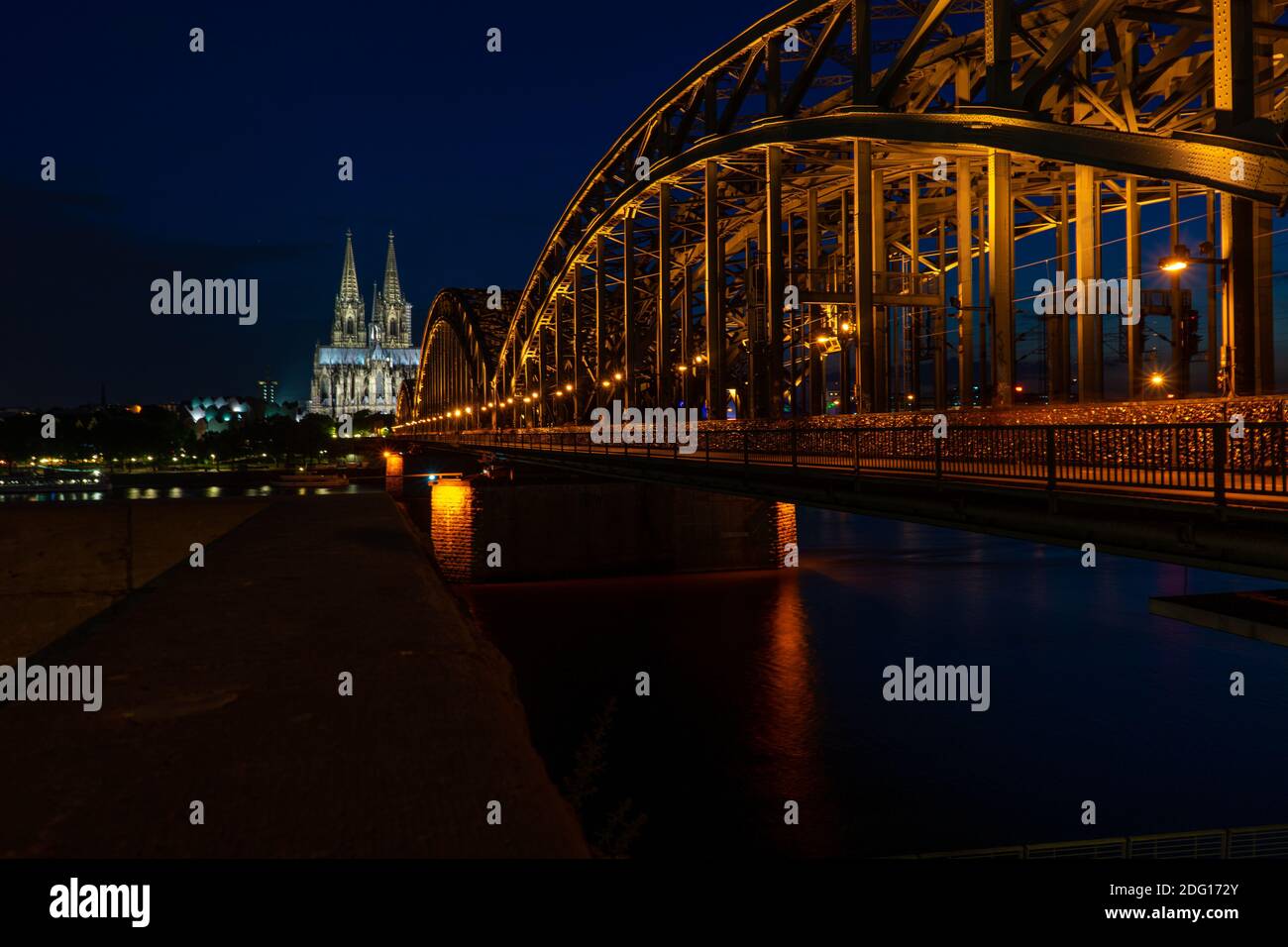 An illuminated Hohenzollern Arch Bridge and a historic ancient ...