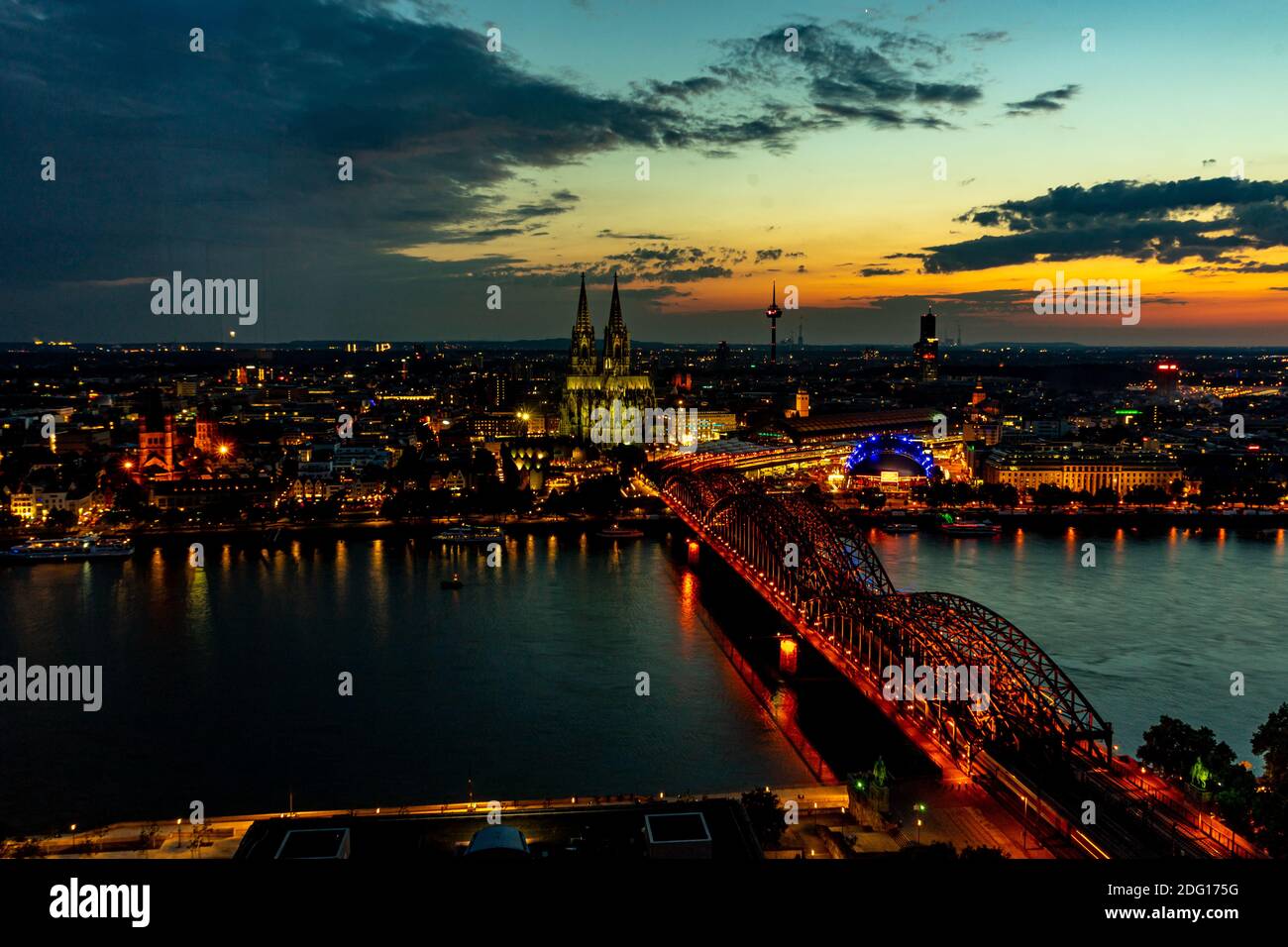 A dramatic sunset cloudscape over Cologne cityscape with a view of ...