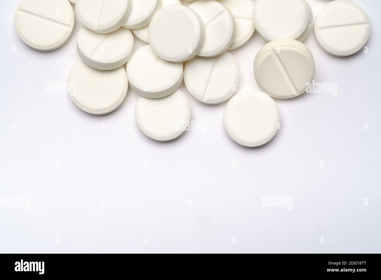 Heap of pills tablets over light grey background Stock Photo - Alamy