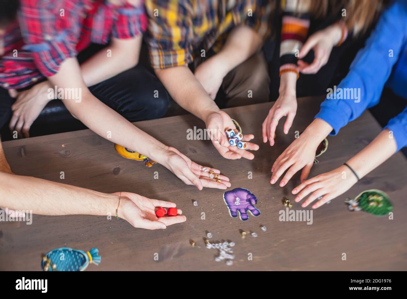 Process of playing board game and having fun with friends and family ...