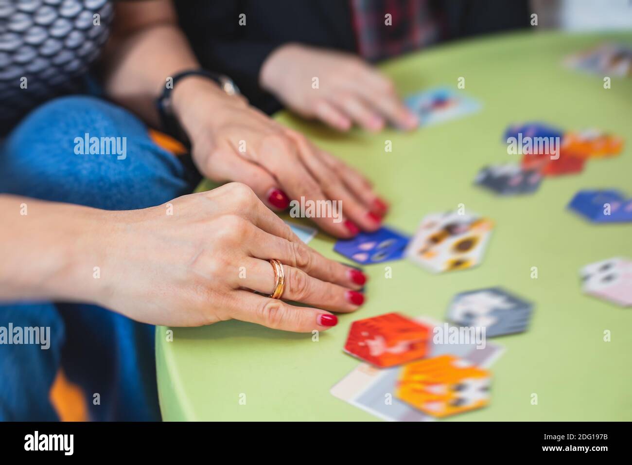 Process of playing board game and having fun with friends and family ...