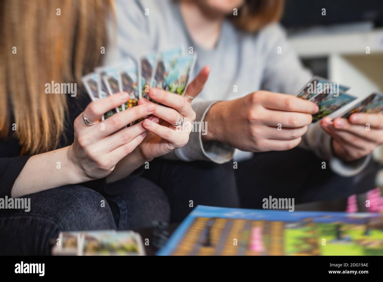 Process of playing board game and having fun with friends and family ...