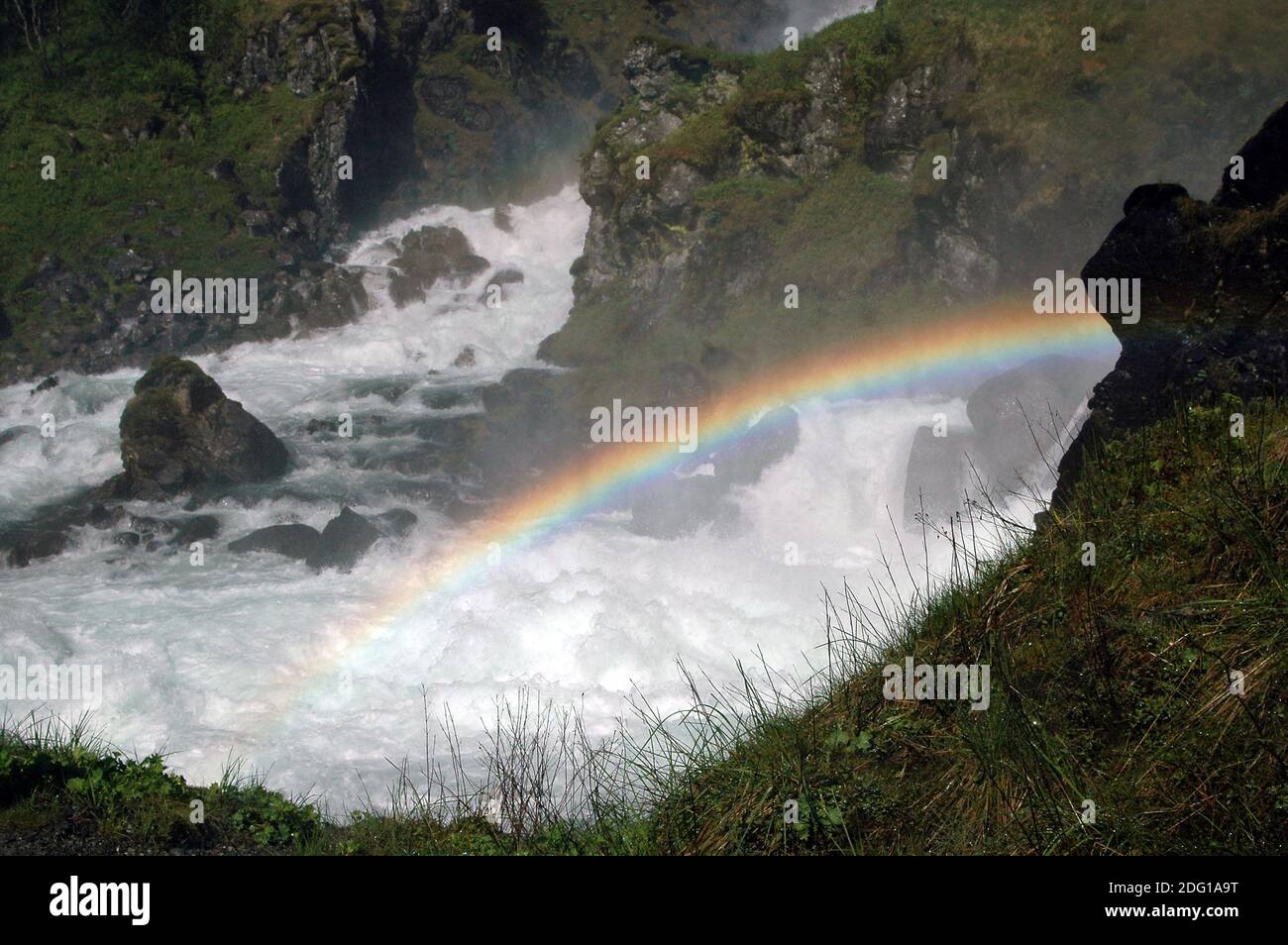 Rainbow over waterfall Stock Photo - Alamy