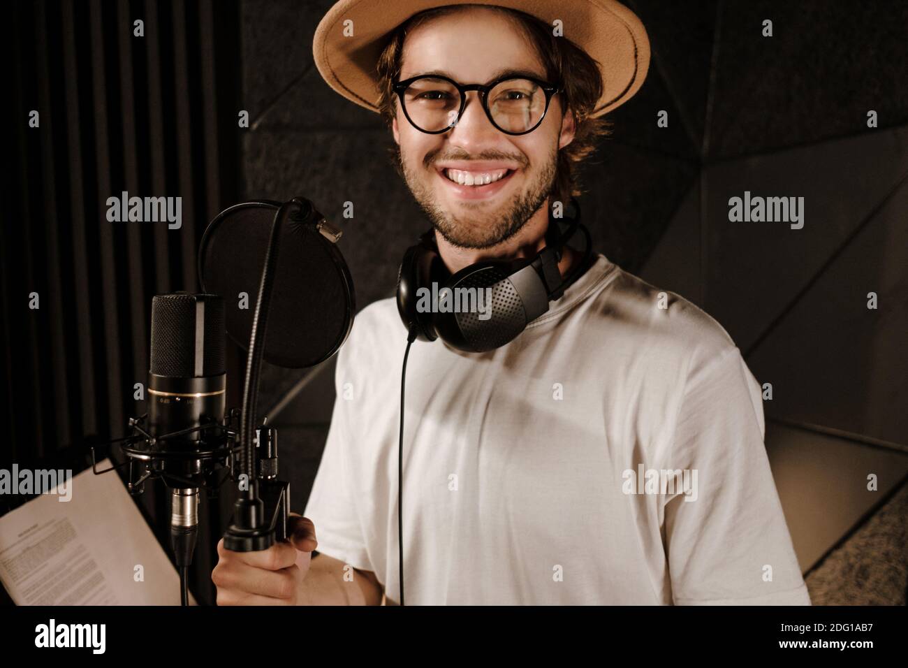 Portrait of handsome cheerful male singer happily looking in camera ...