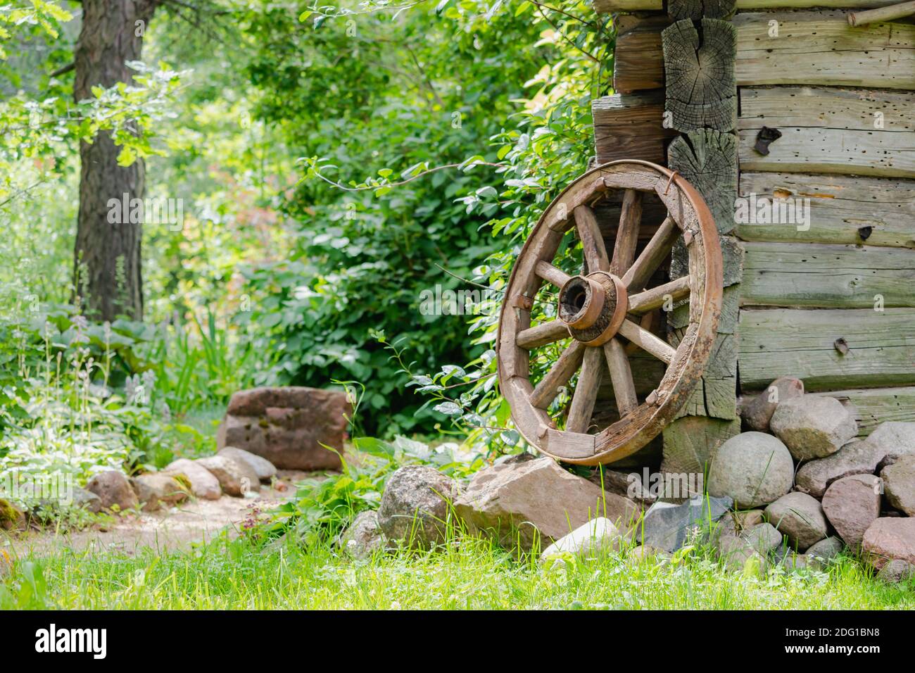 Old wooden wheel in willage near old wodden house in Lithuania Stock ...