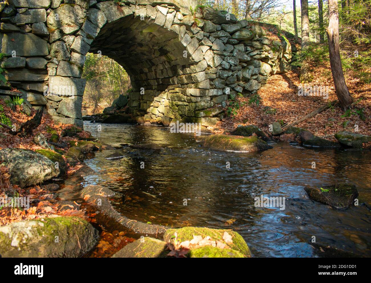 Hand constructed bridge built in 1866 spans a flowing stream Stock ...