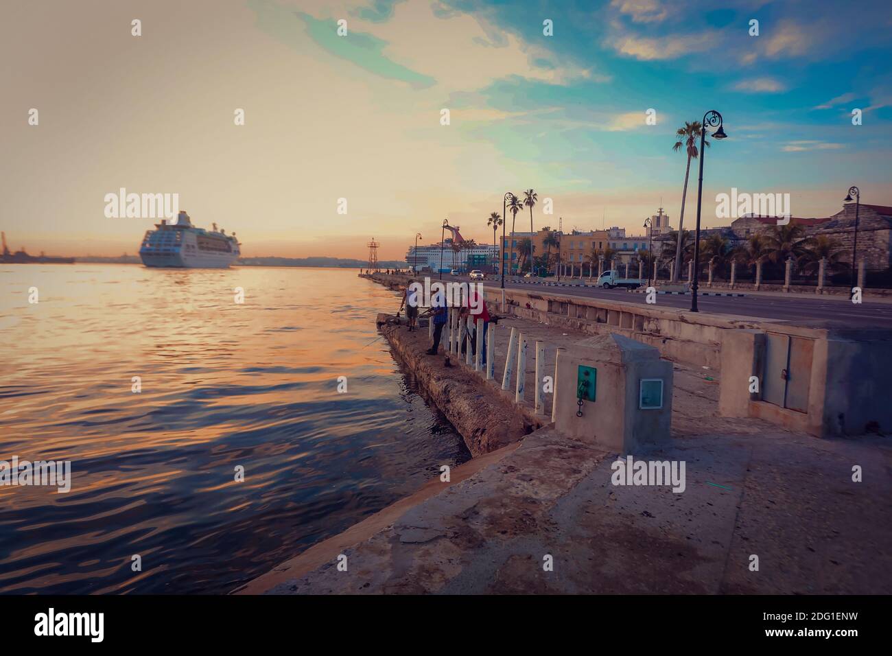 A Caribbean sunset taken in Cuba, cruise ship is passing to dock in ...