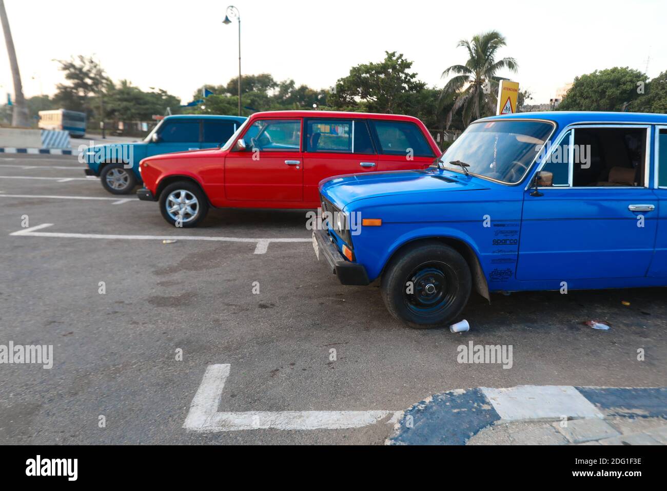 Three colorfully Chevrolet Cabriolet classic cars parked before the ...