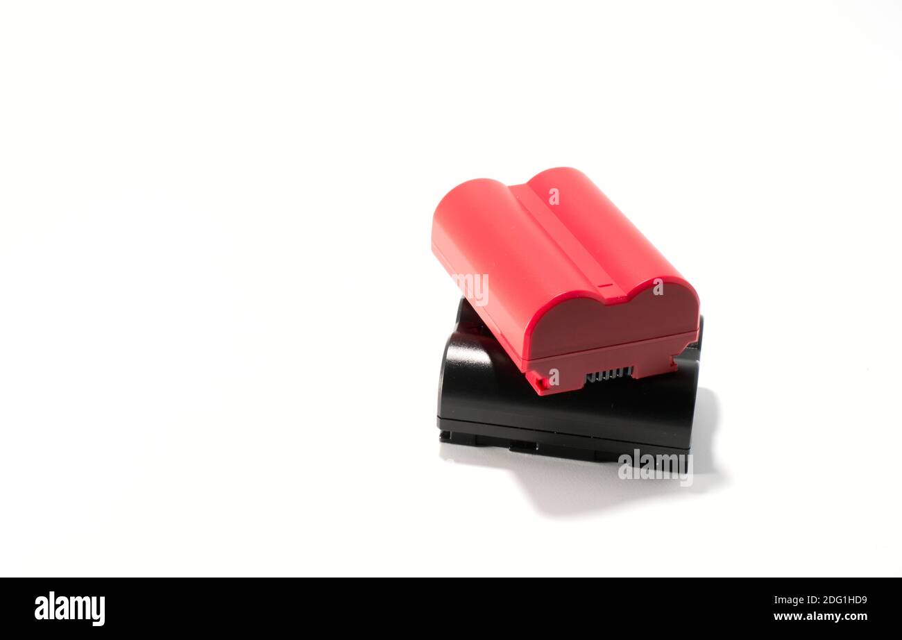 Red and black battery pack for small single lens reflex camera. Copy ...