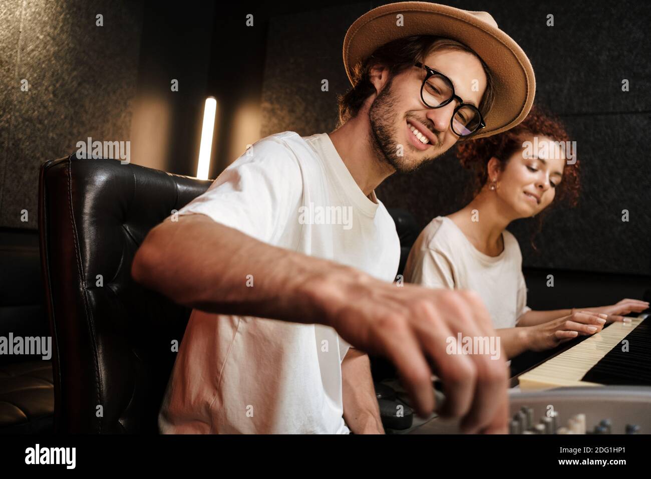 Young stylish people creating music in modern recording studio ...