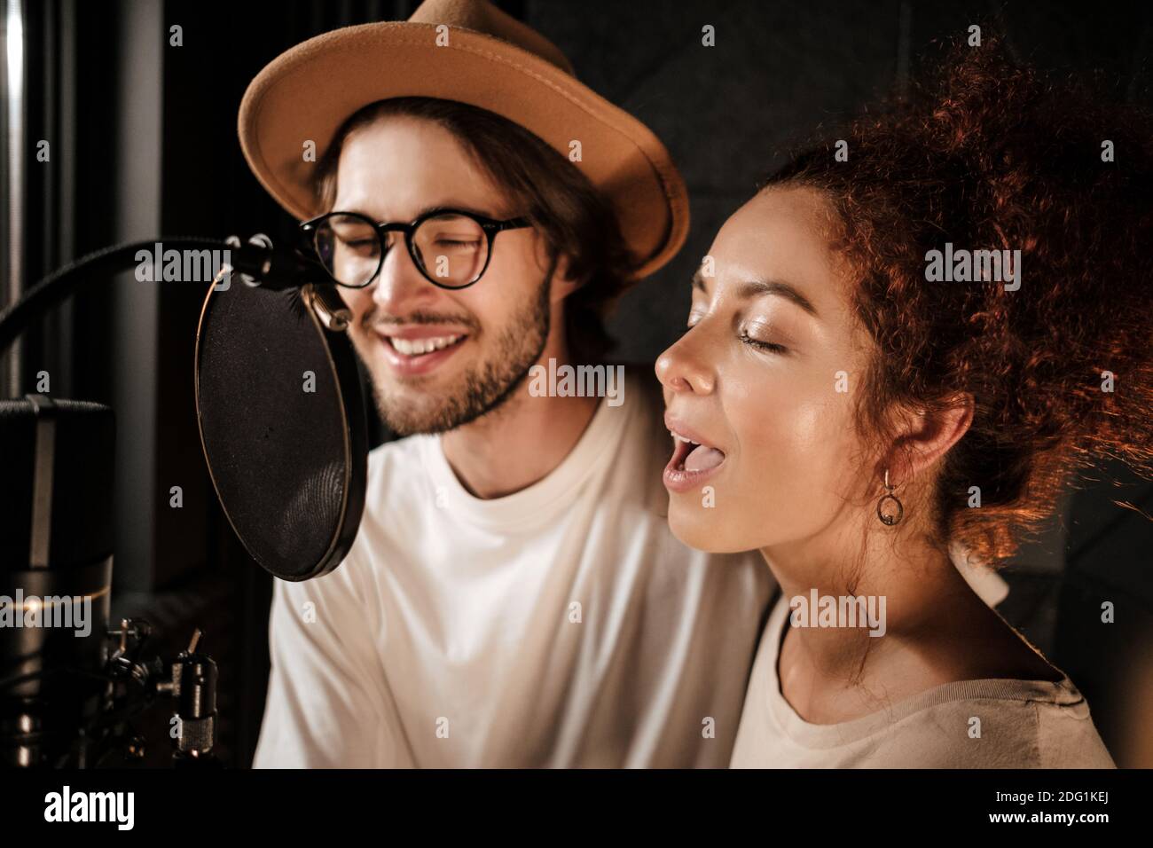 Young attractive musicians sensually singing working together on new ...