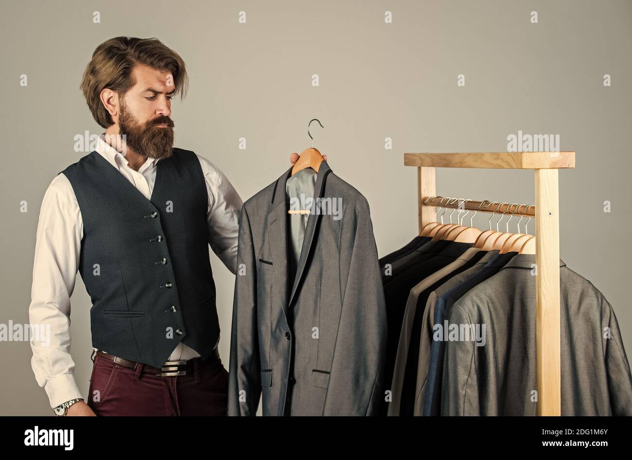 Fits perfect. Man clothing in boutique. Man with suit. tailor in his ...