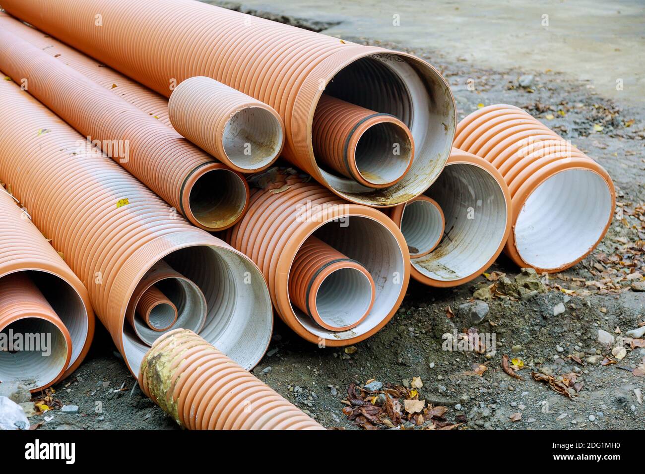 Plastic PVC pipes stacked in rows at construction site on ...
