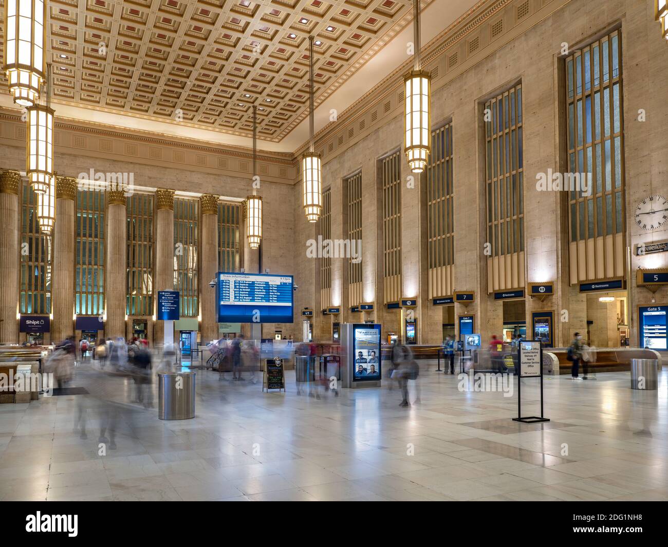 Interior of 30th Street Railway Station with blurry passenger travelers ...