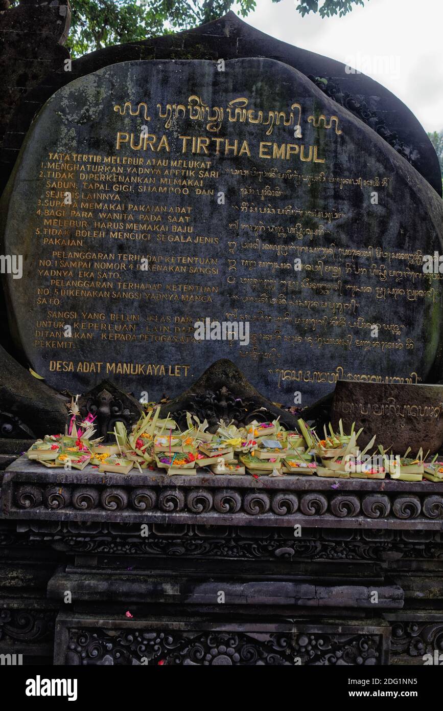 Offerings placed before Balinese text on carved stone at the Pura ...