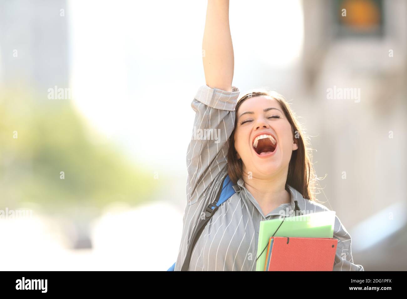 Front view portrait of an excited student celebrating success in the ...