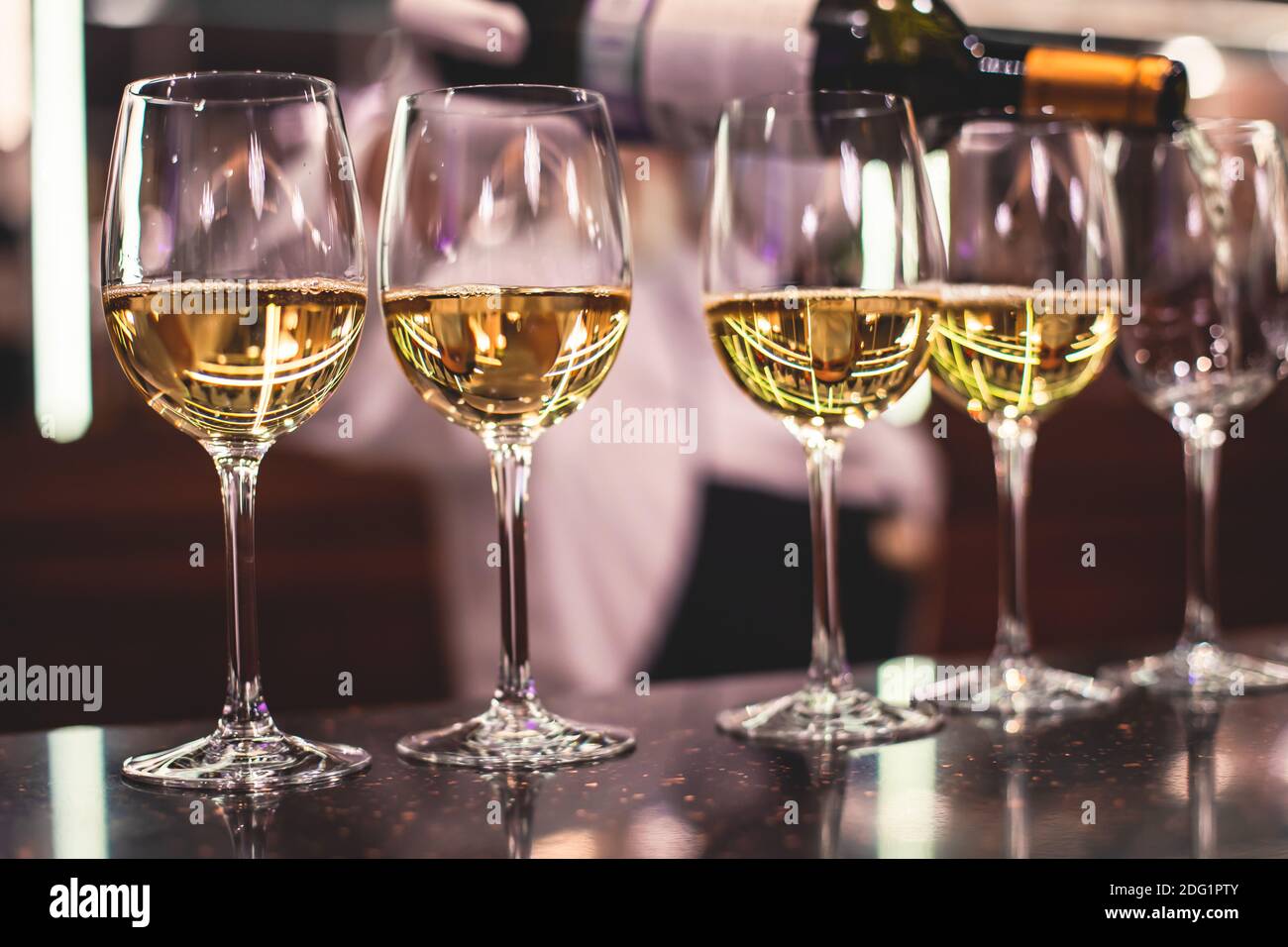 Line of alcohol setting on catering banquet table, bartender pouring ...