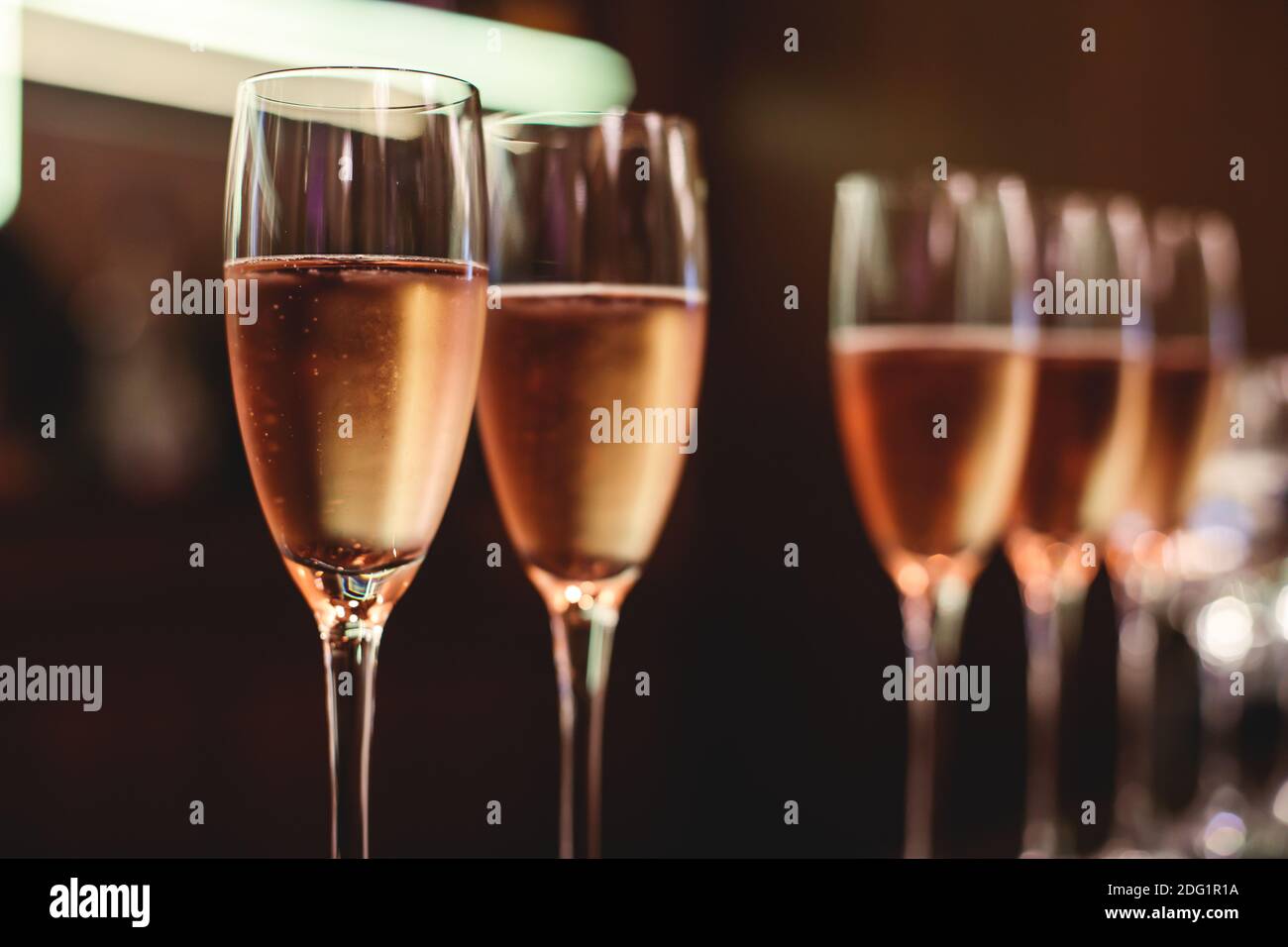 Line of alcohol setting on catering banquet table, bartender pouring ...