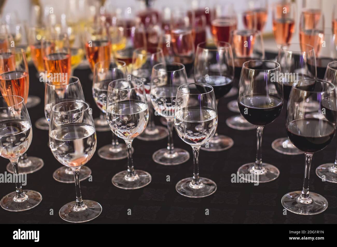 Line of alcohol setting on catering banquet table, bartender pouring ...