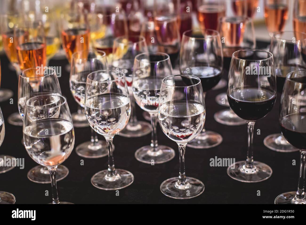 Line of alcohol setting on catering banquet table, bartender pouring ...