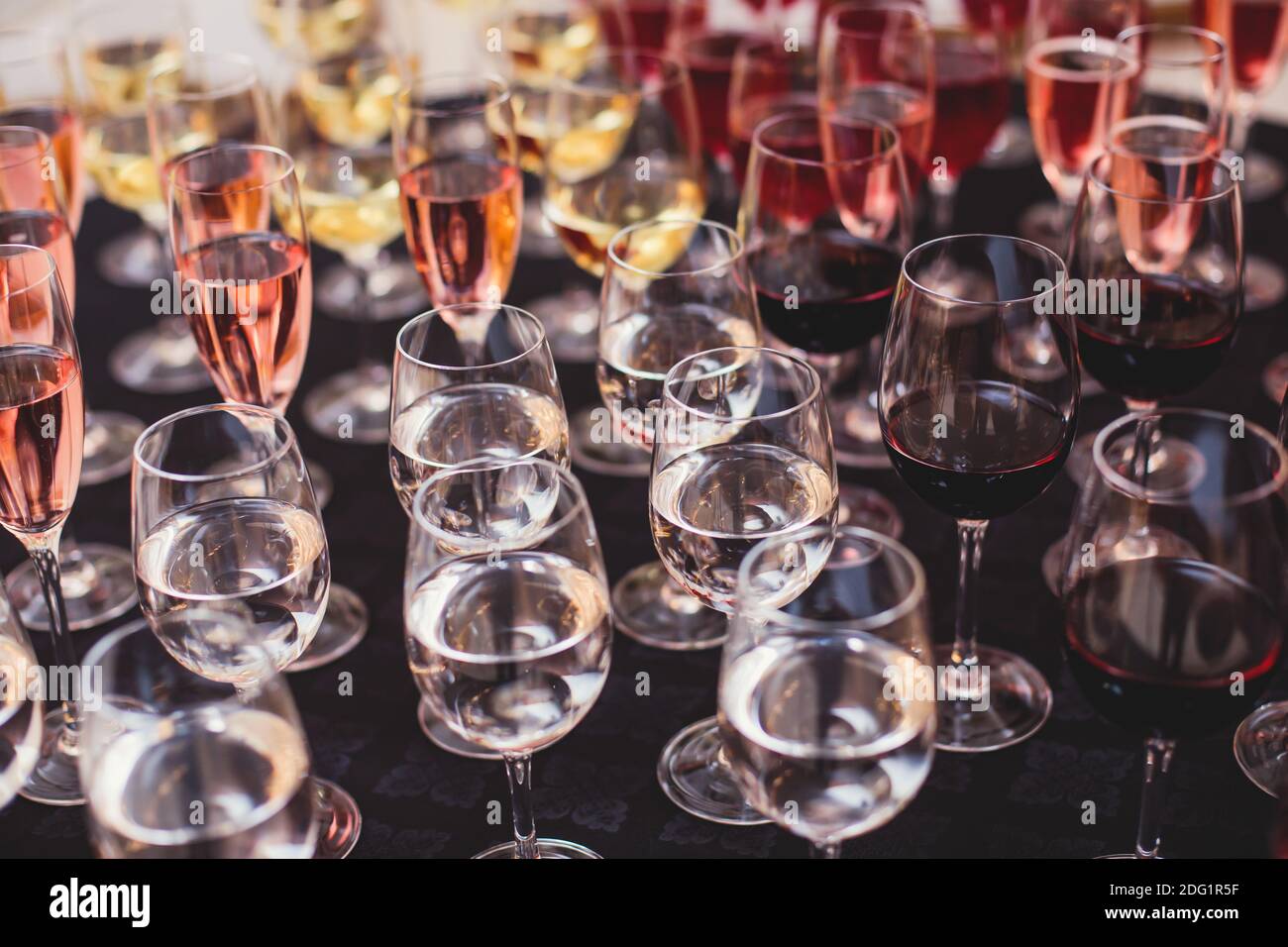 Line of alcohol setting on catering banquet table, bartender pouring ...