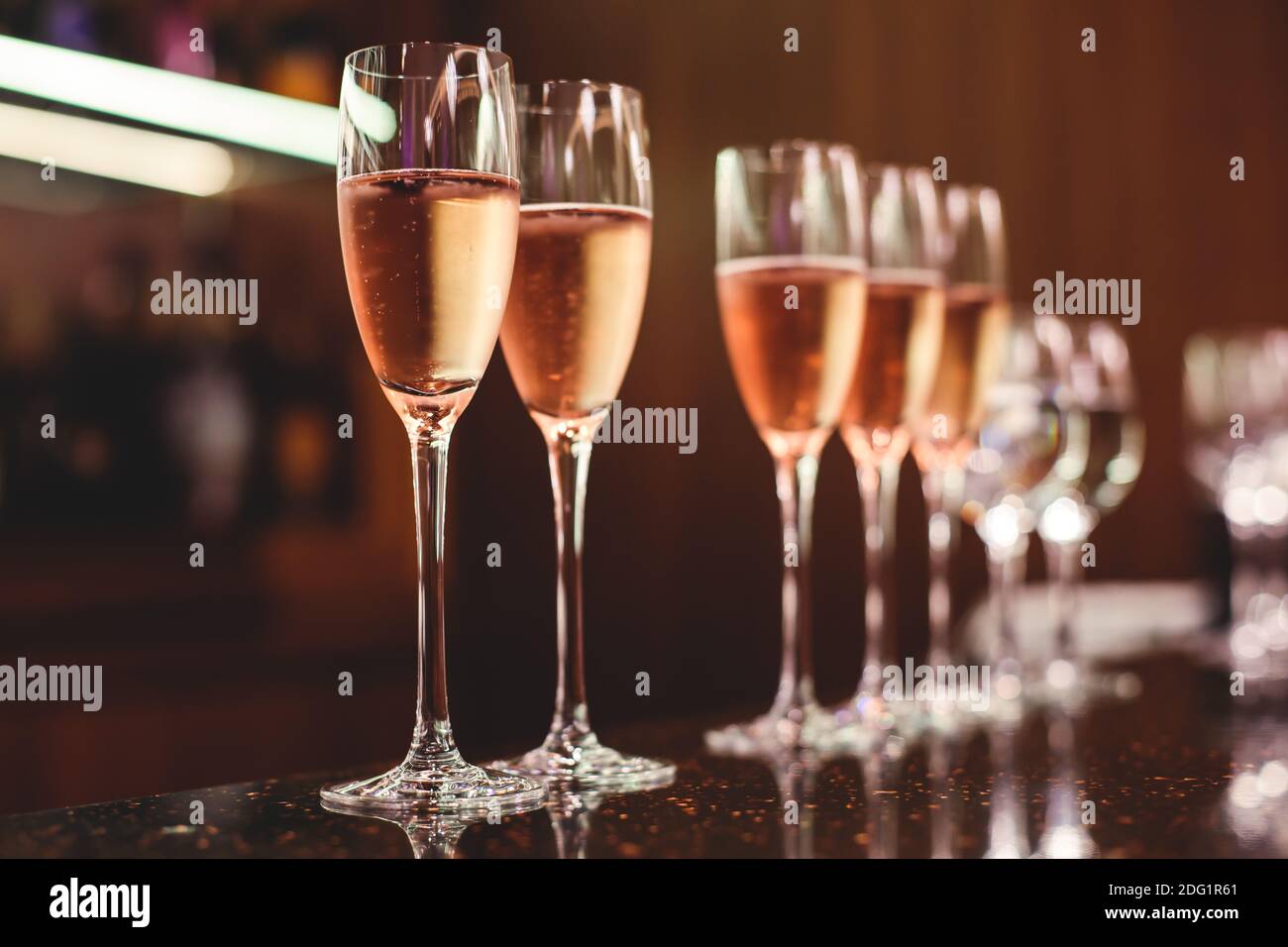 Line of alcohol setting on catering banquet table, bartender pouring ...
