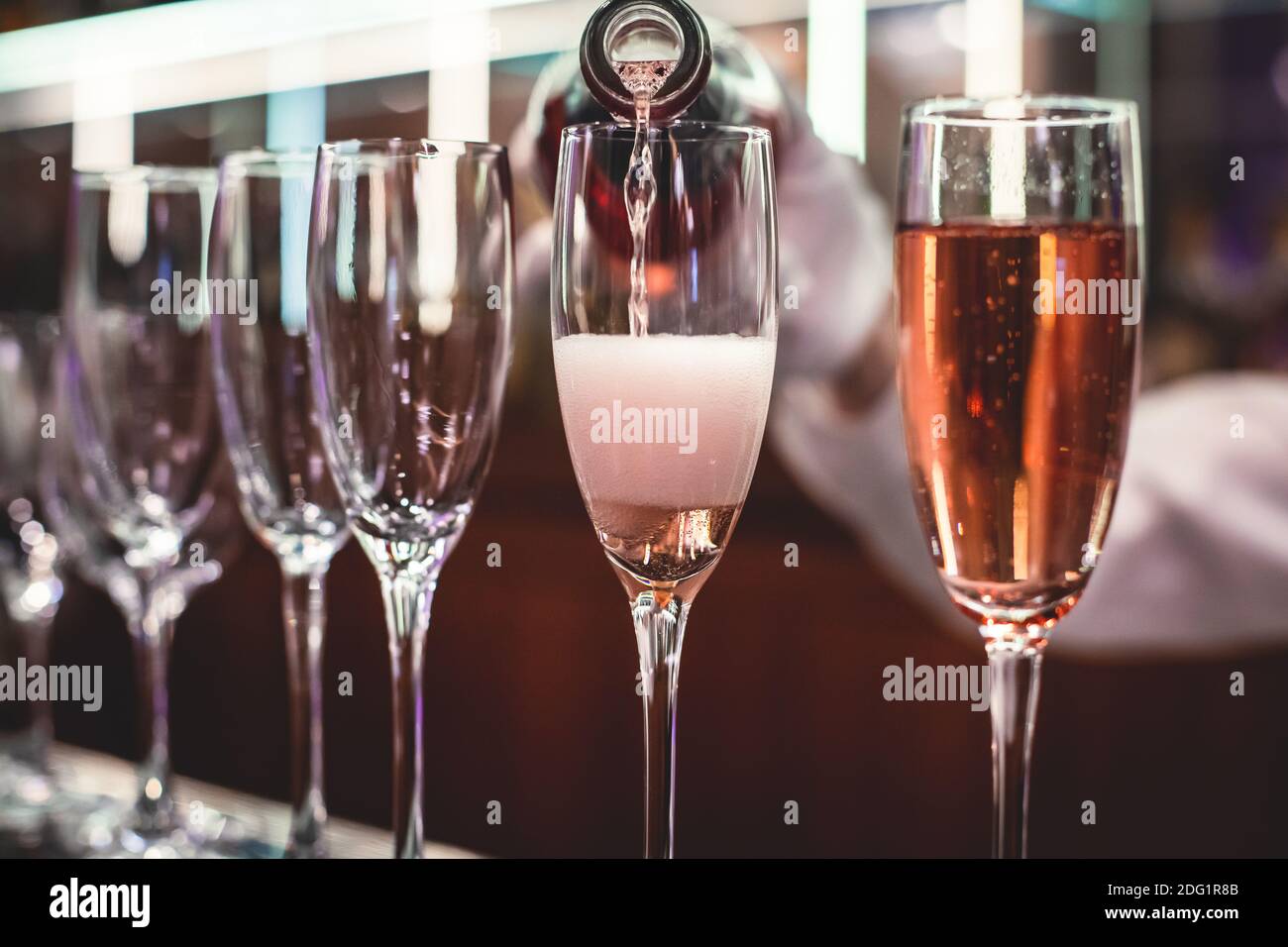 Line of alcohol setting on catering banquet table, bartender pouring ...