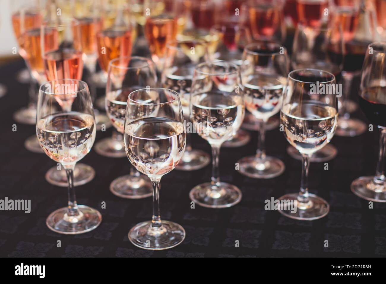 Line of alcohol setting on catering banquet table, bartender pouring ...