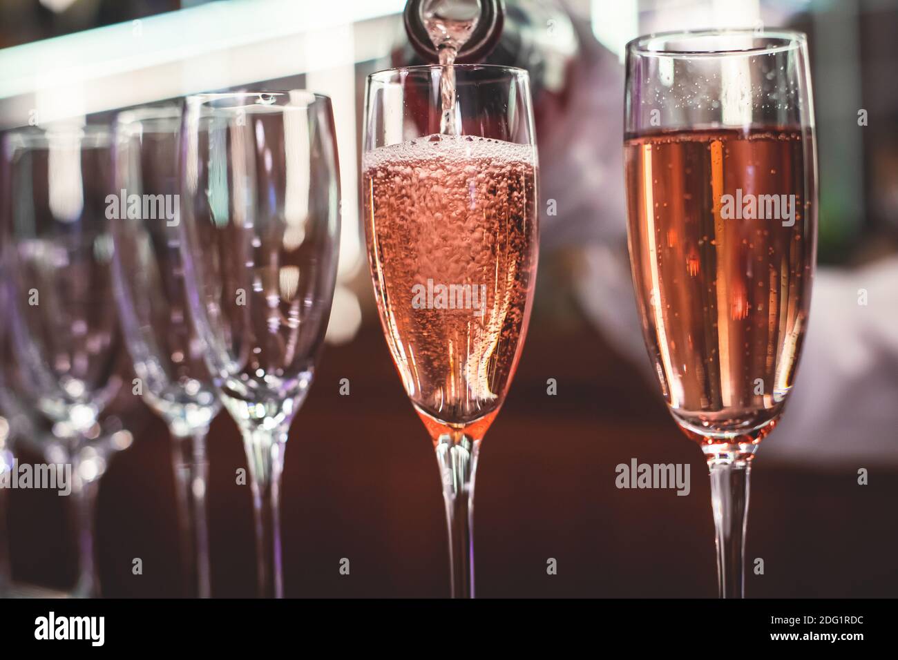 Line of alcohol setting on catering banquet table, bartender pouring ...