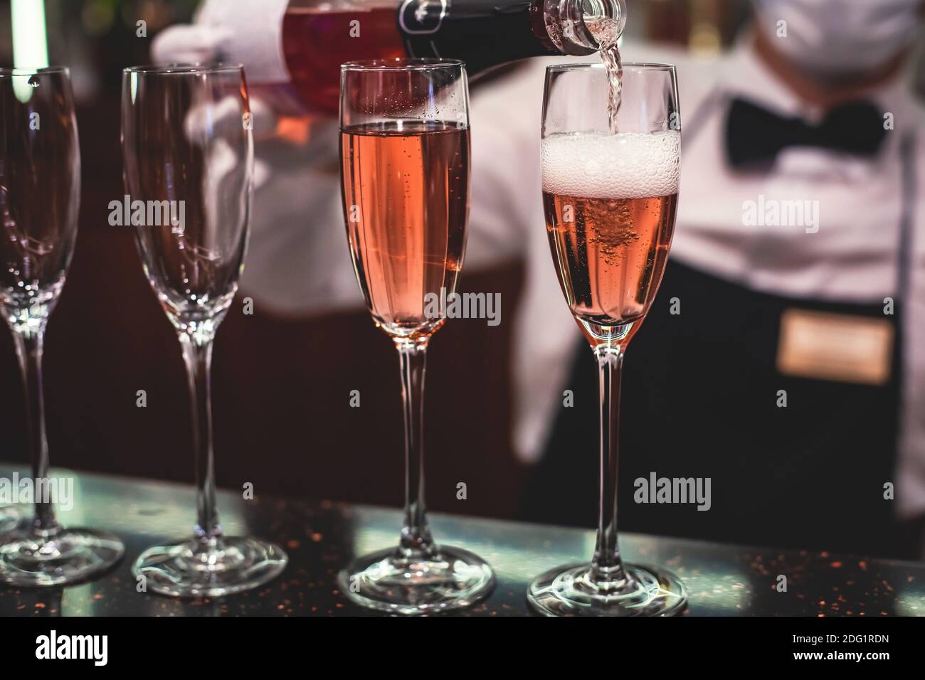 Line of alcohol setting on catering banquet table, bartender pouring ...