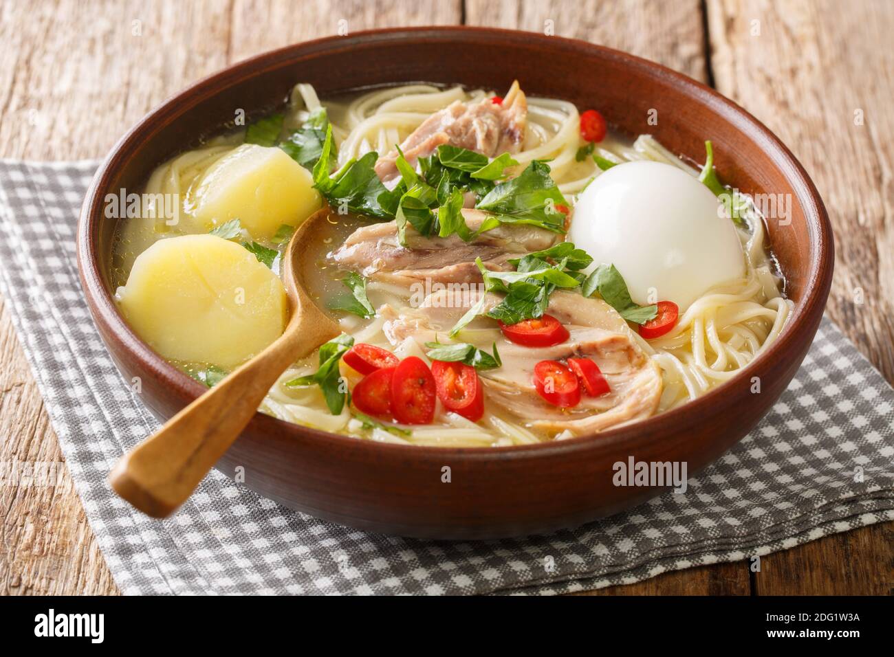 Peruvian Caldo de Gallina Chicken Soup closeup in the plate on the ...