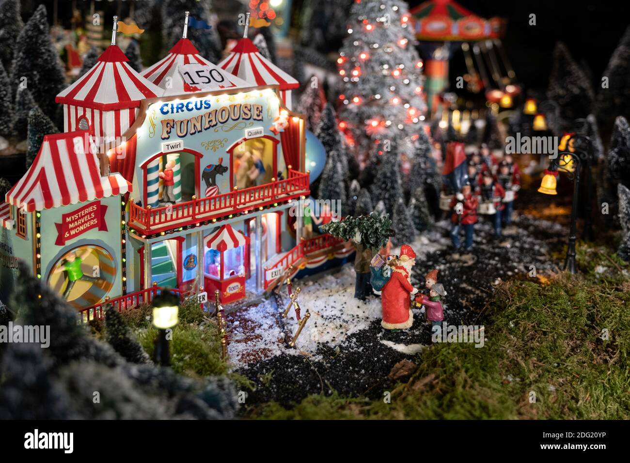 Circus fun house with Christmas lights and toy dolls against a ...