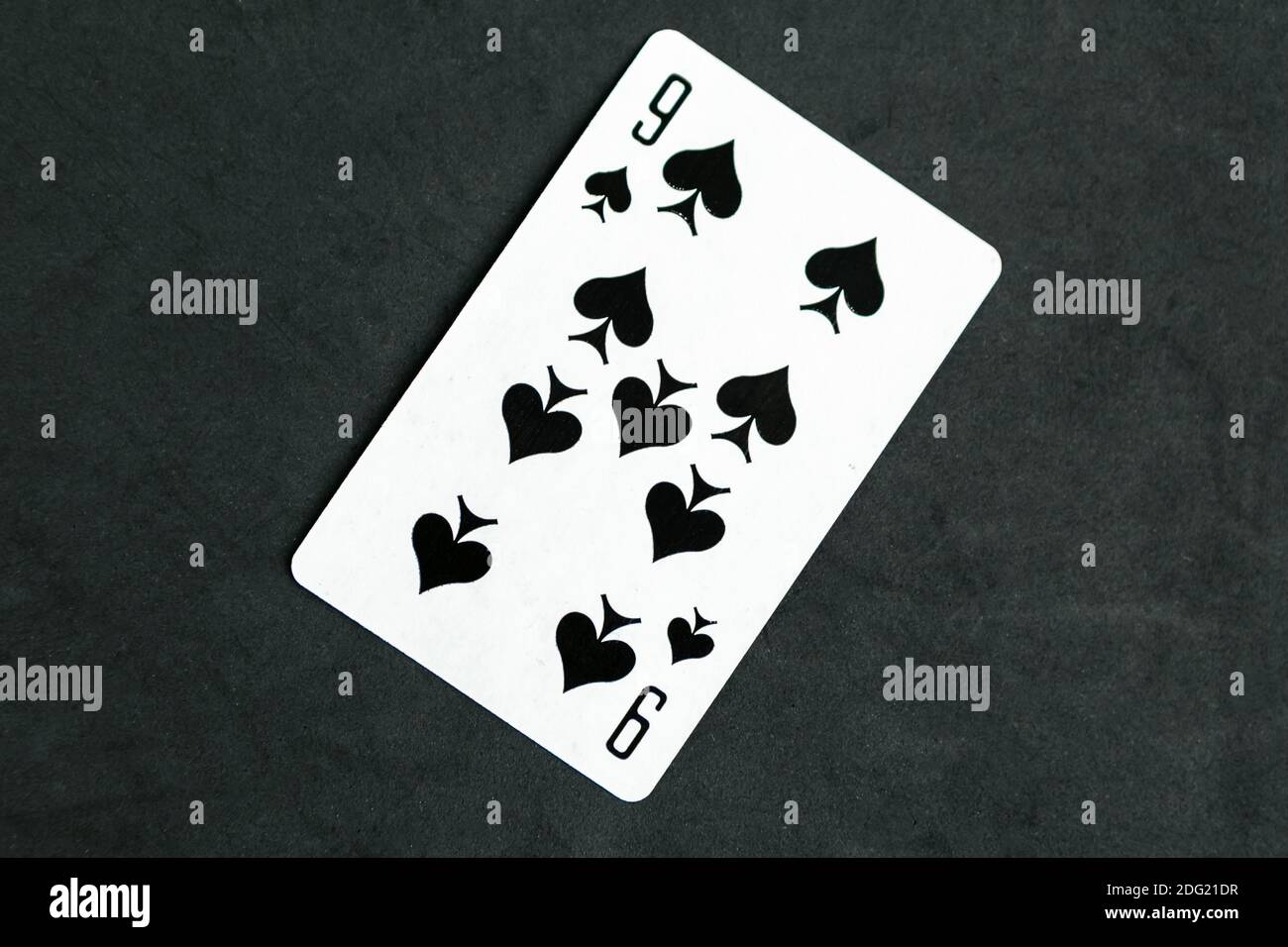Nine of Spades playing card, black background Stock Photo - Alamy