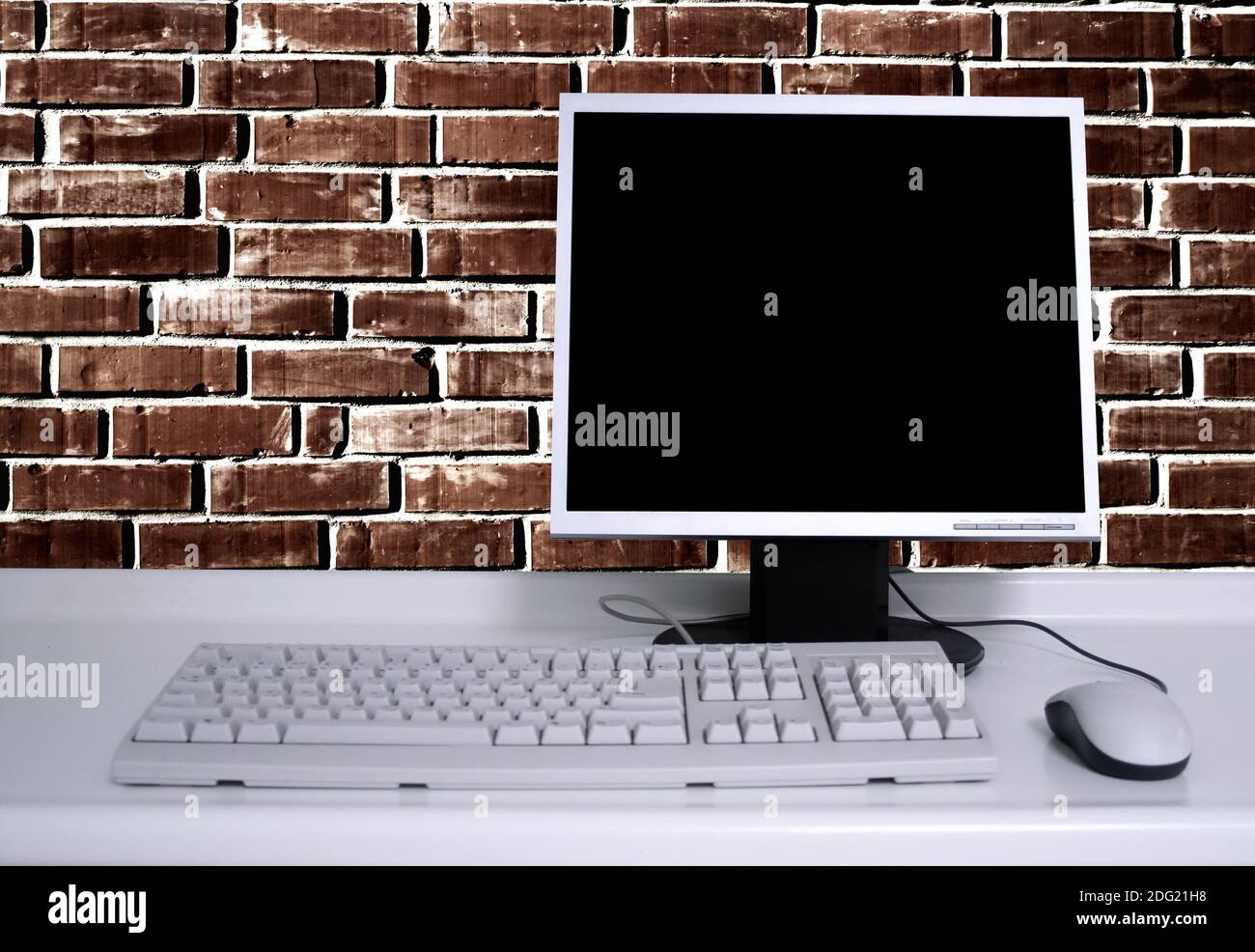 PC with black desktop and brick wall background Stock Photo - Alamy
