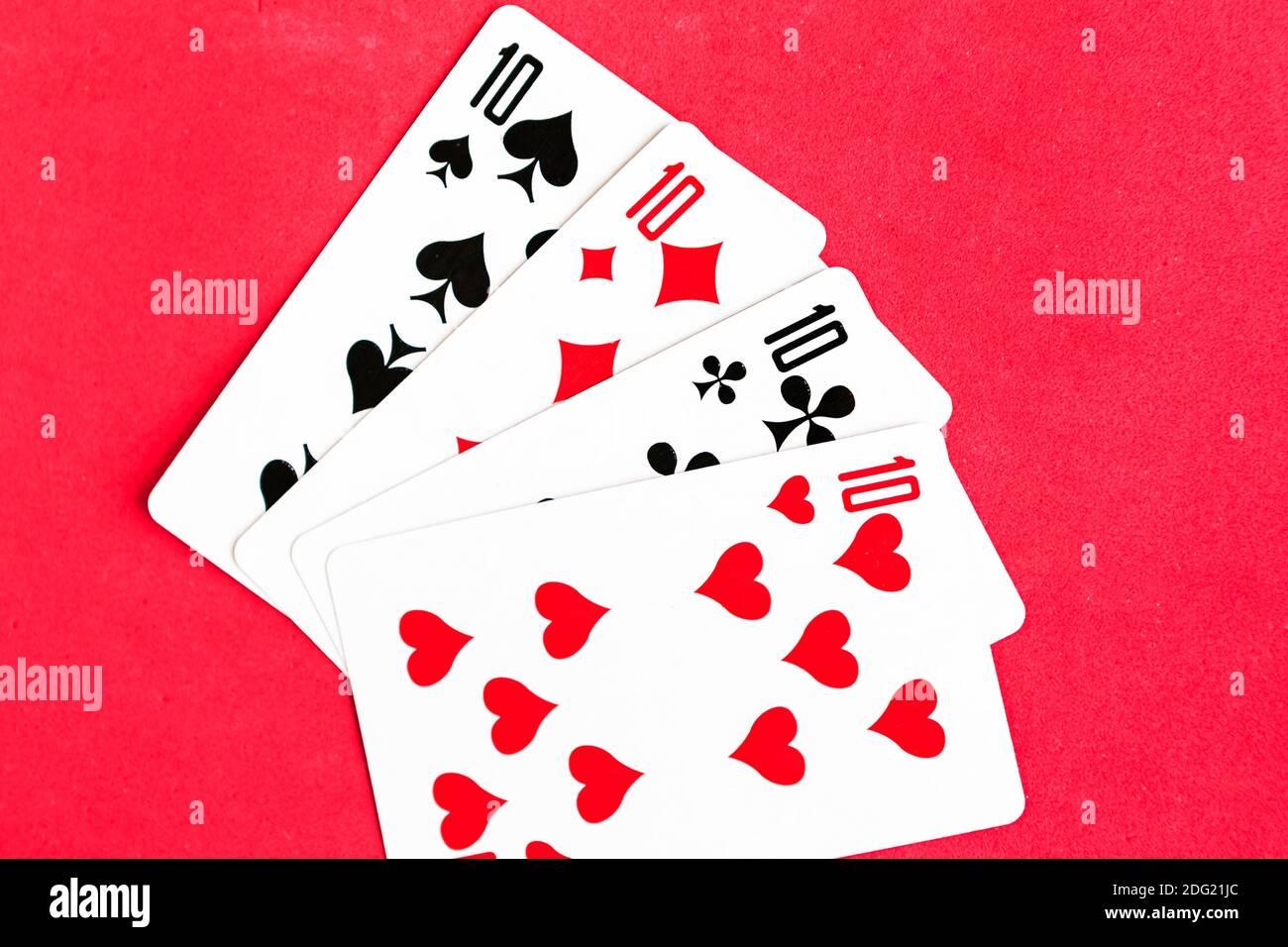 Poker quads playing card, red background Stock Photo - Alamy