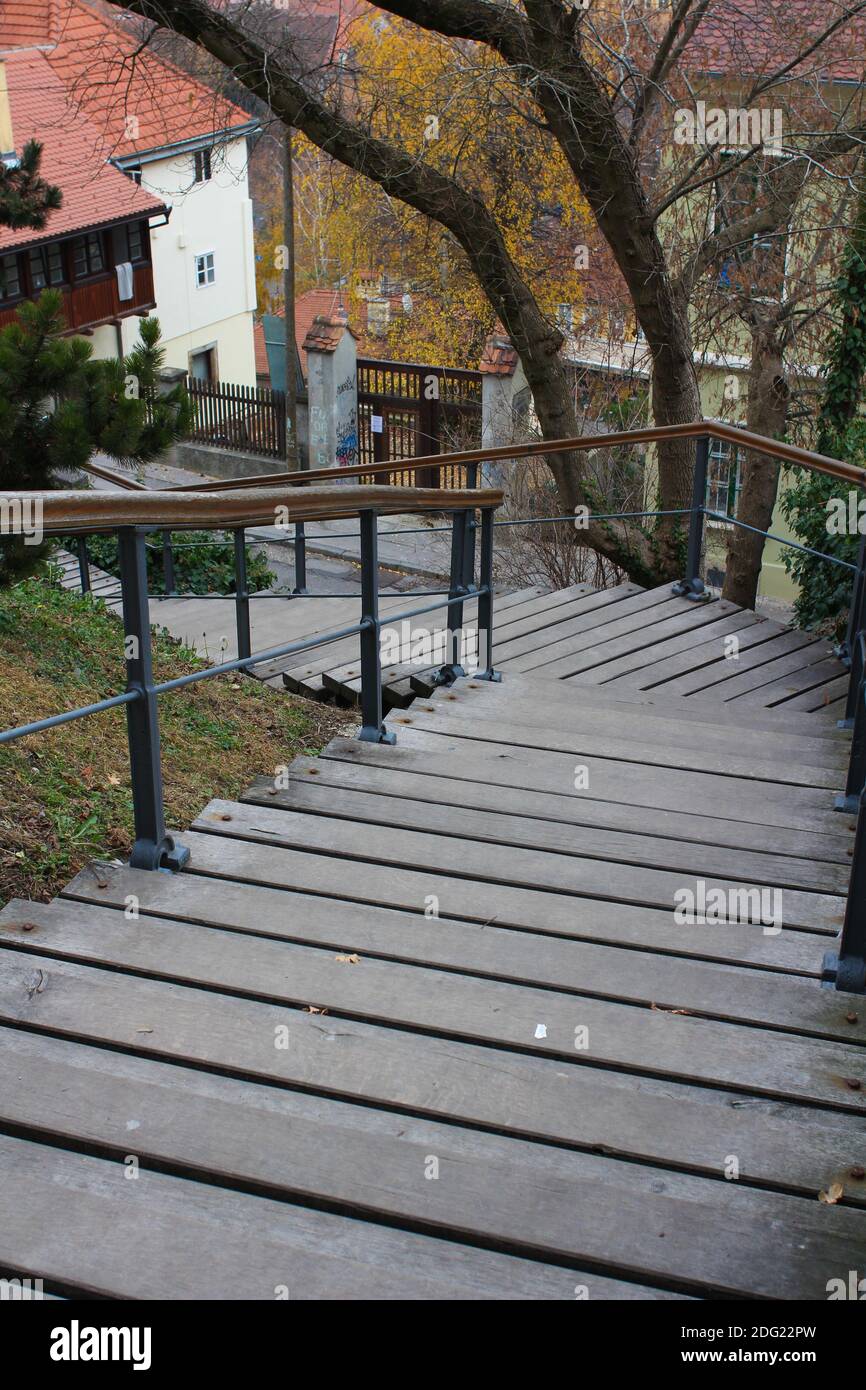 Wooden Stairs Going Downwards with a bent to the left Stock Photo - Alamy