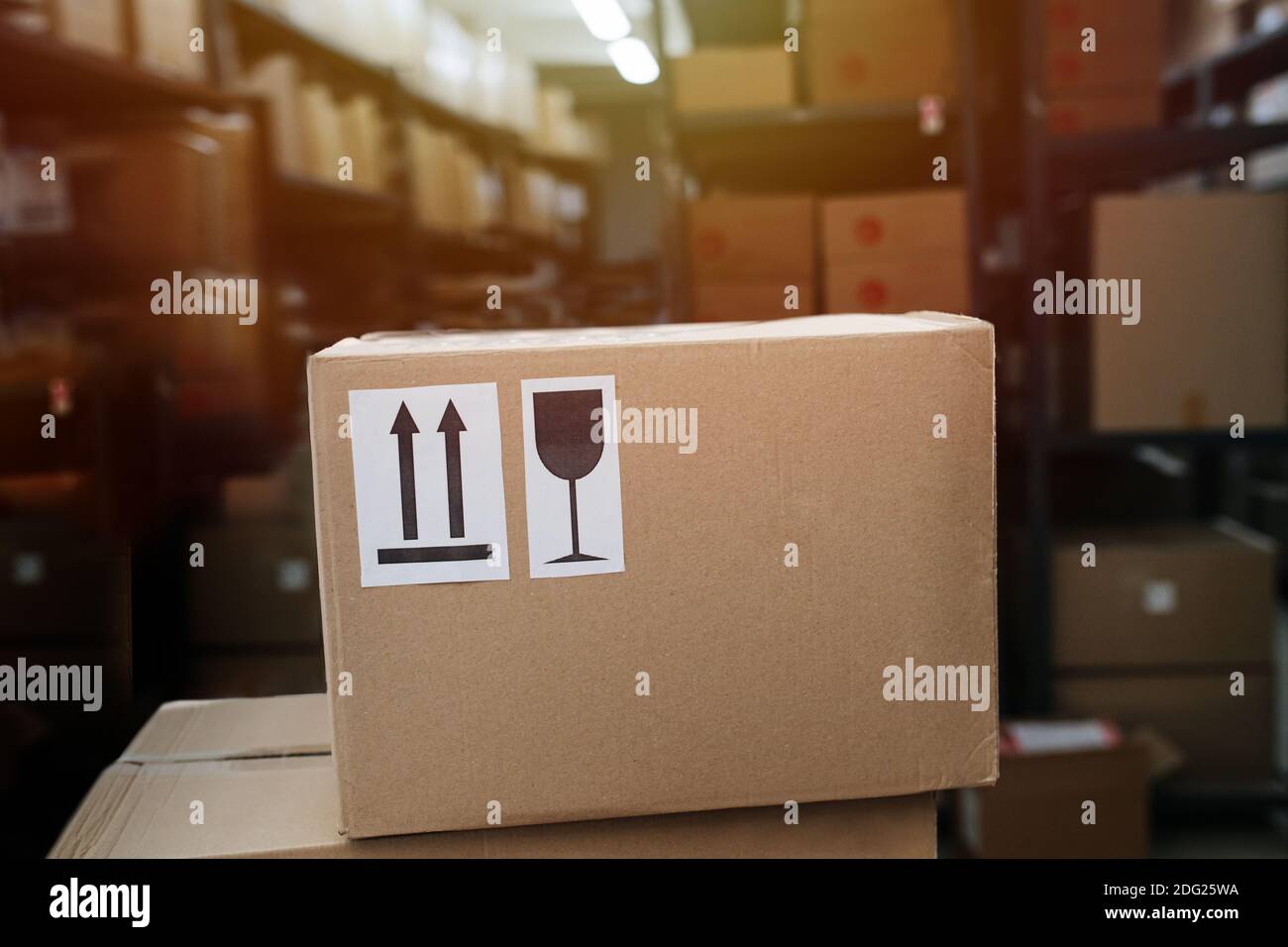 Marked with stickers carton box on a warehouse, stacked with similar ...