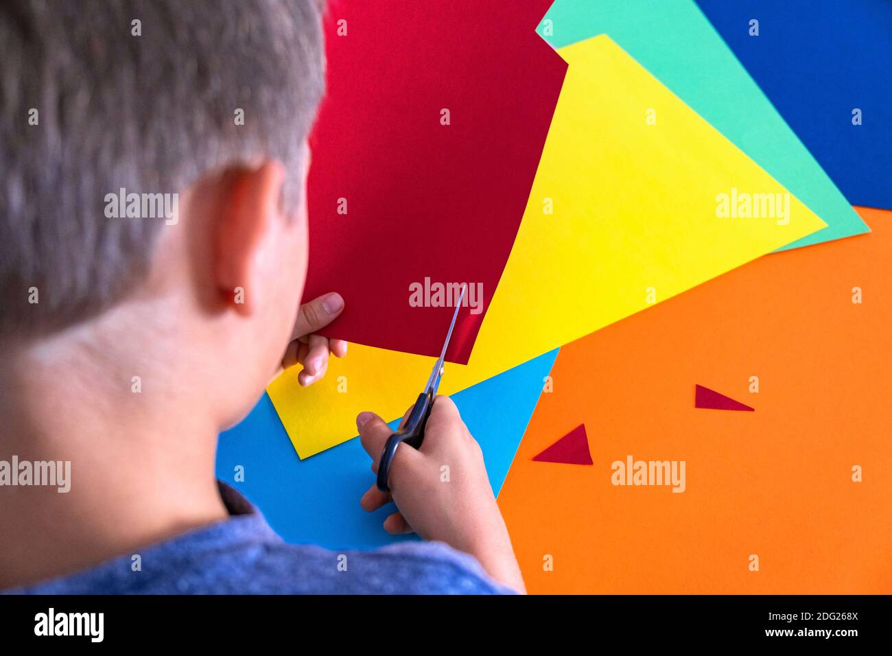 Paper crafts for kids. Child hands cutting colored paper with scissors ...