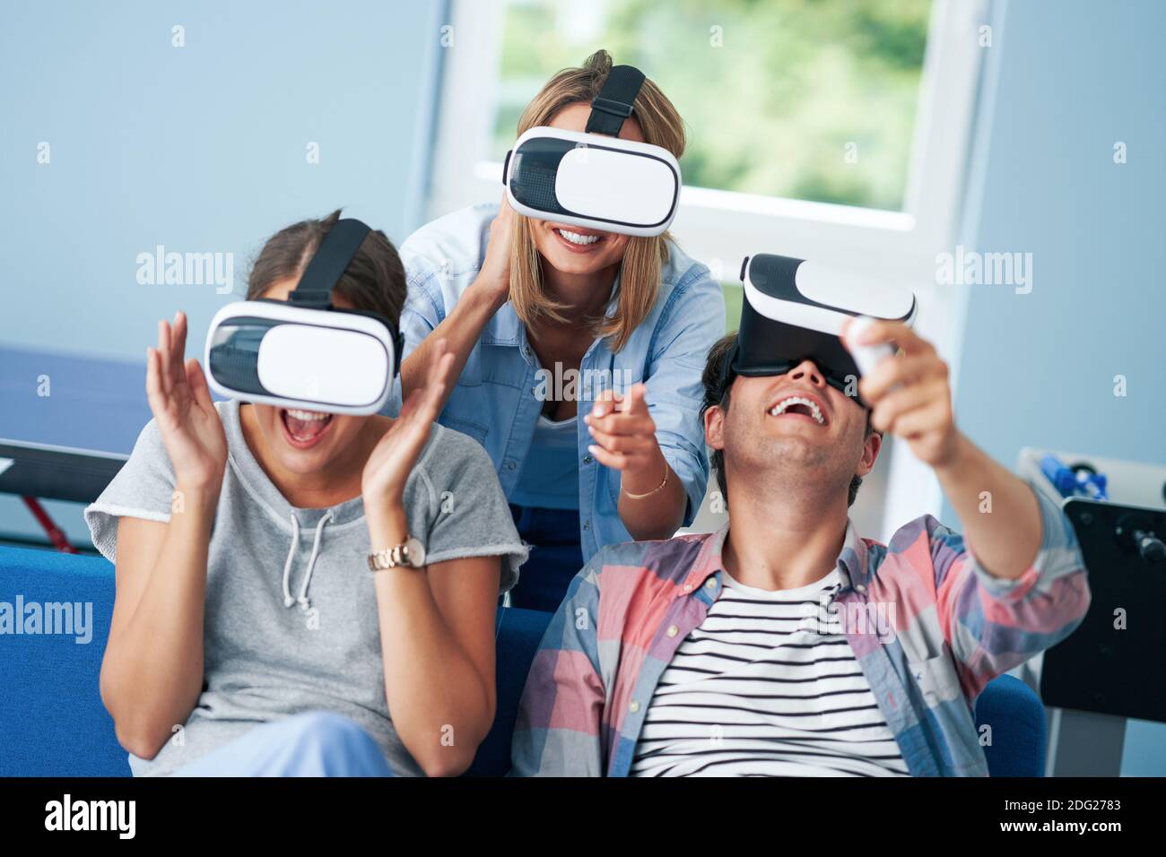 Couple of students playing video games in the campus Stock Photo - Alamy