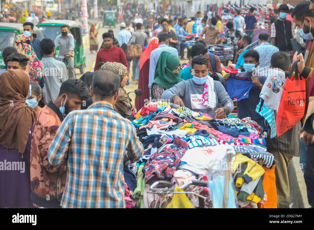 Customers are busy buying winter clothes at street shops in Sylhet ...