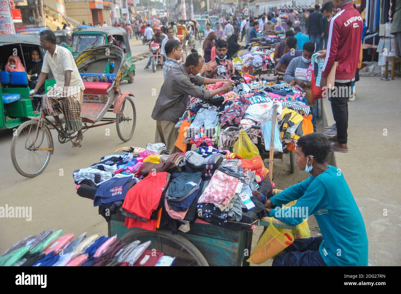 Customers are busy buying winter clothes at street shops in Sylhet ...