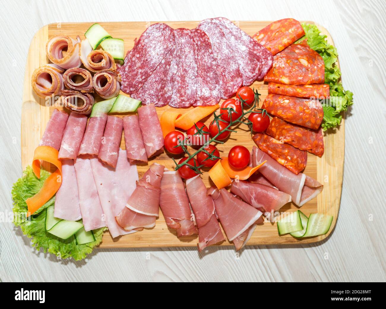 The buffet at the reception. Assortment of canapes on wooden board ...