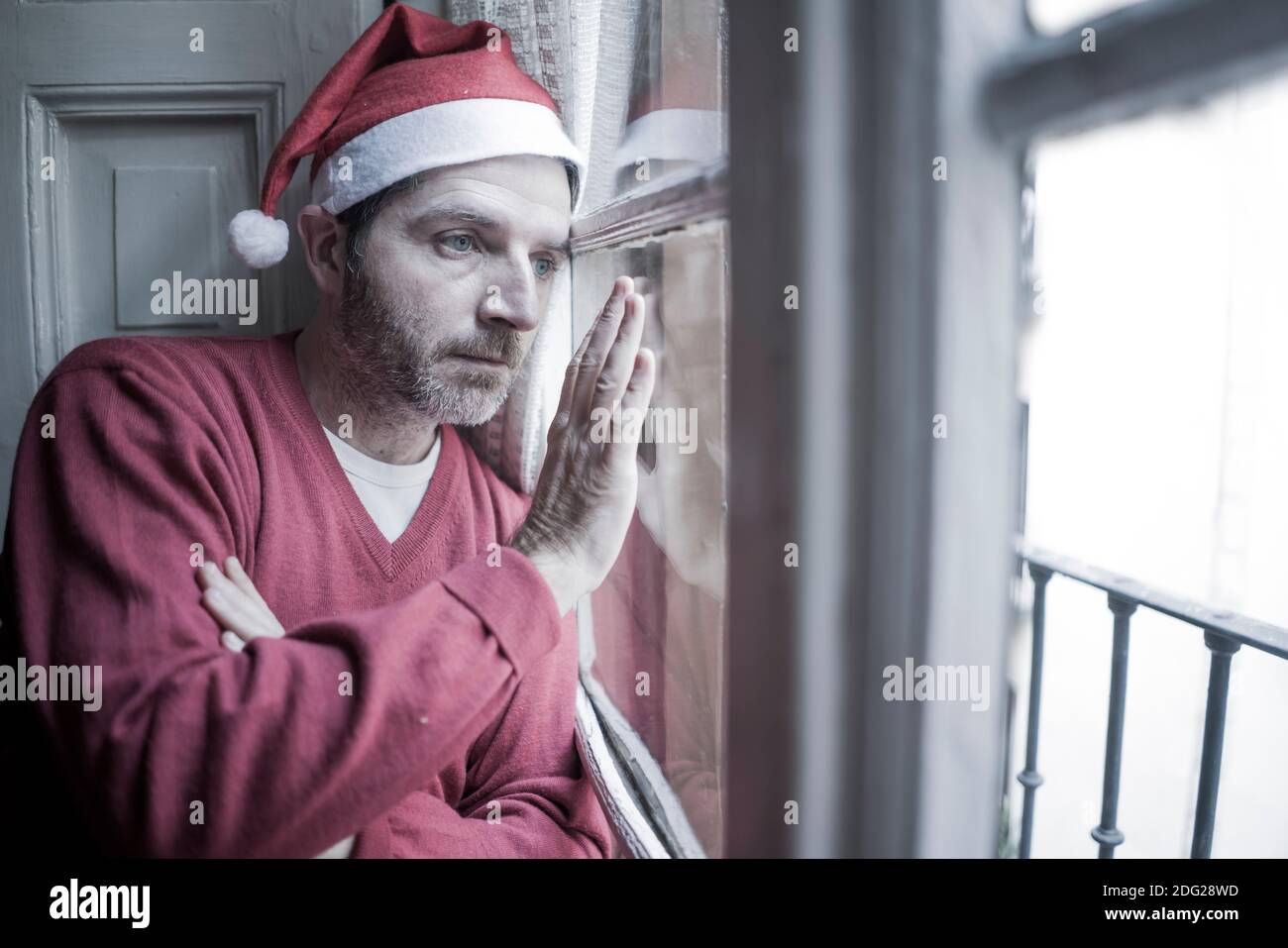 dramatic lifestyle portrait of sad and depressed man in Santa Claus hat ...