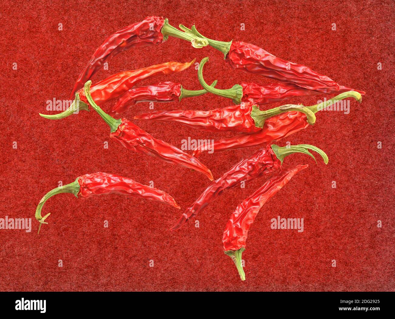 hot chili peppers over chili ground powder Stock Photo - Alamy