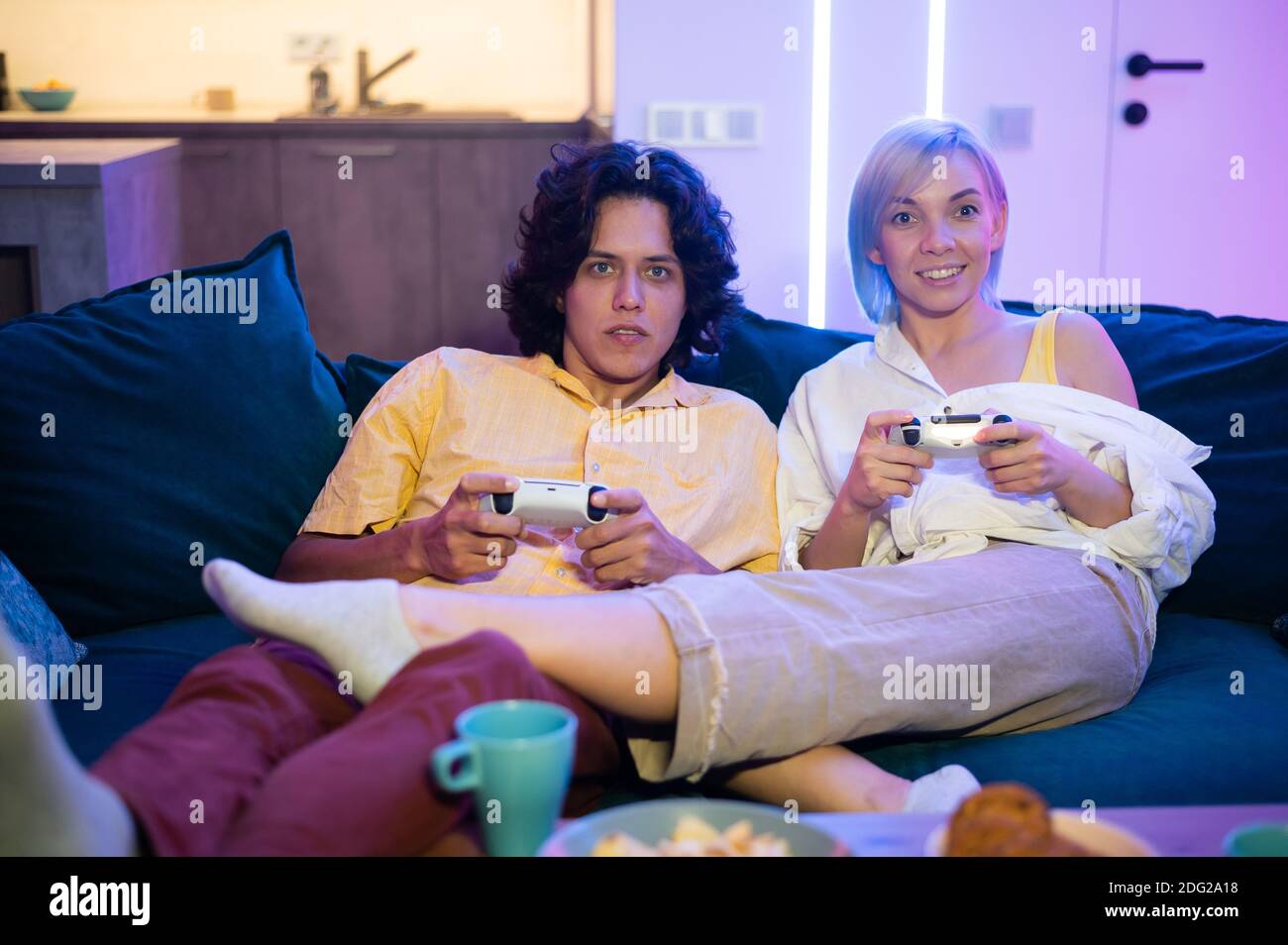 Happy boyfriend and girlfriend playing video games and holding ...