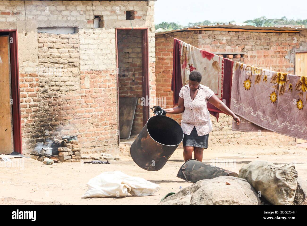 A woman goes about her house chores in Hopley Harare. Hopley is one of ...