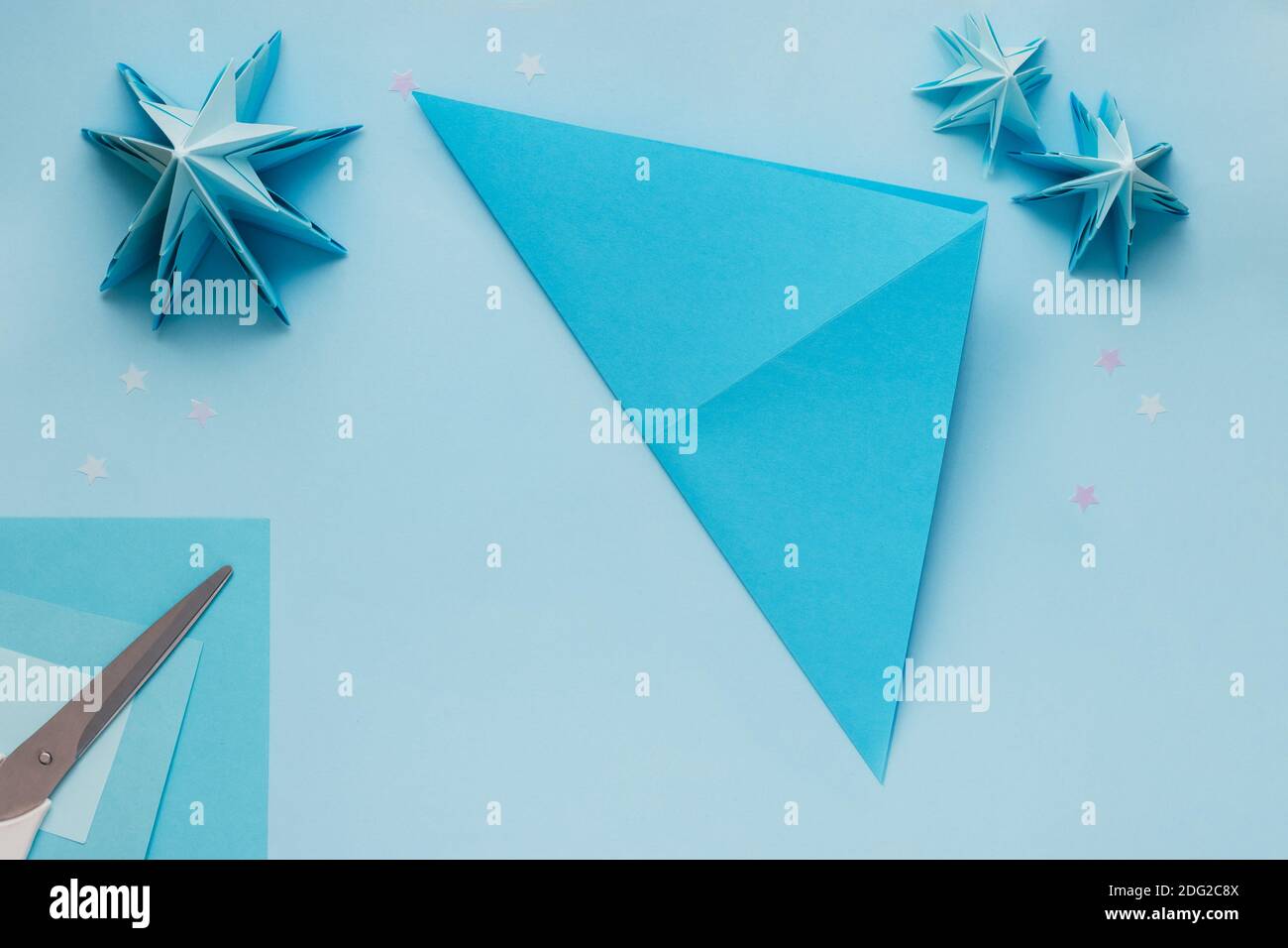 Simple origami 3D Christmas tree made from blue paper. Step by step ...
