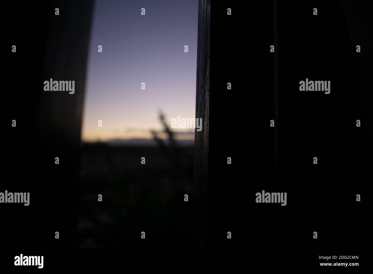 An abstract shot of a blurry purple shaded sunset sky seen through a ...