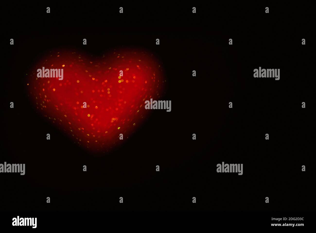 On black isolated background red blurred heart from bokeh. Greeting ...