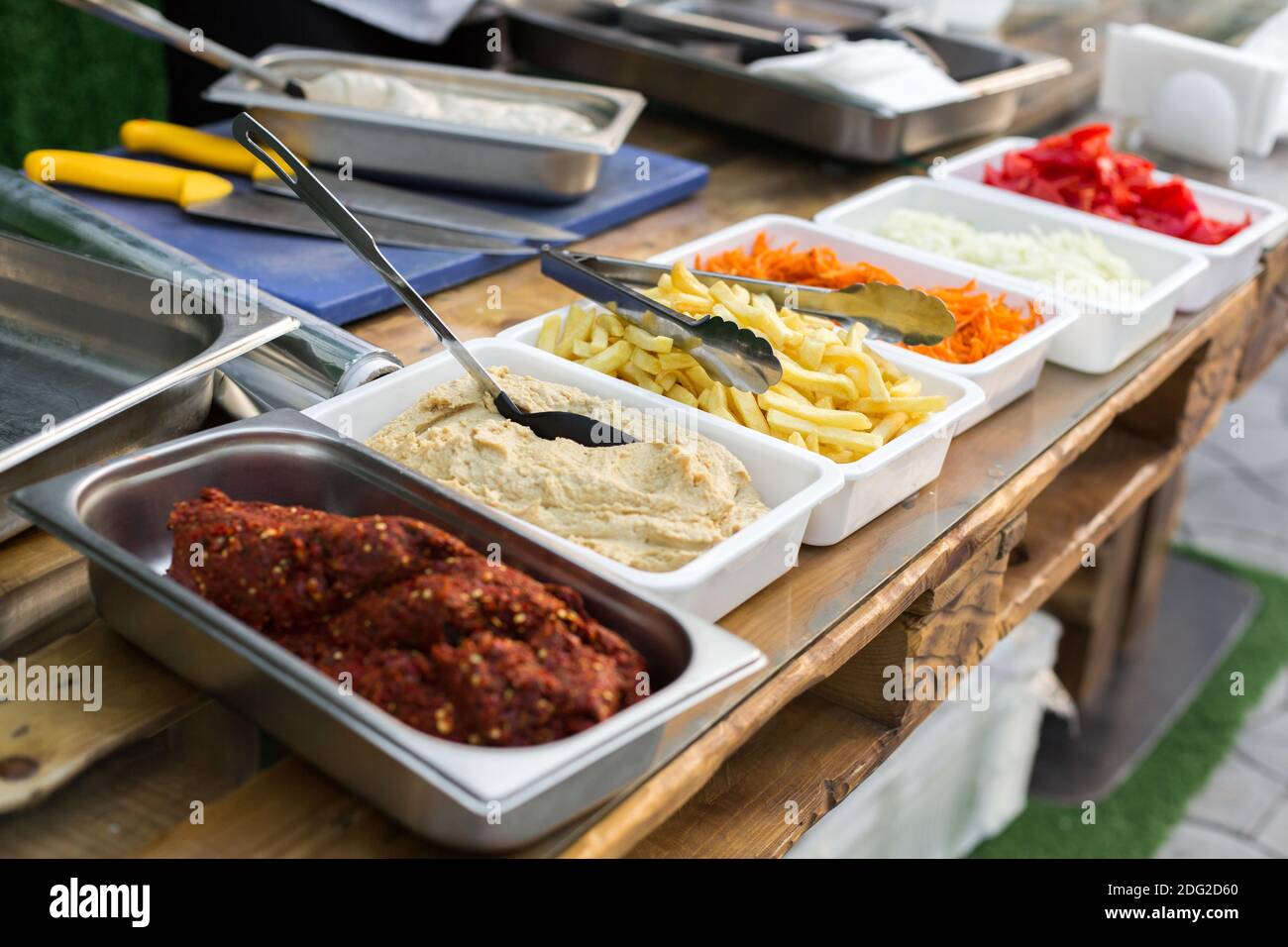 open air kitchen products for cooking falafel in dishes on a wooden ...